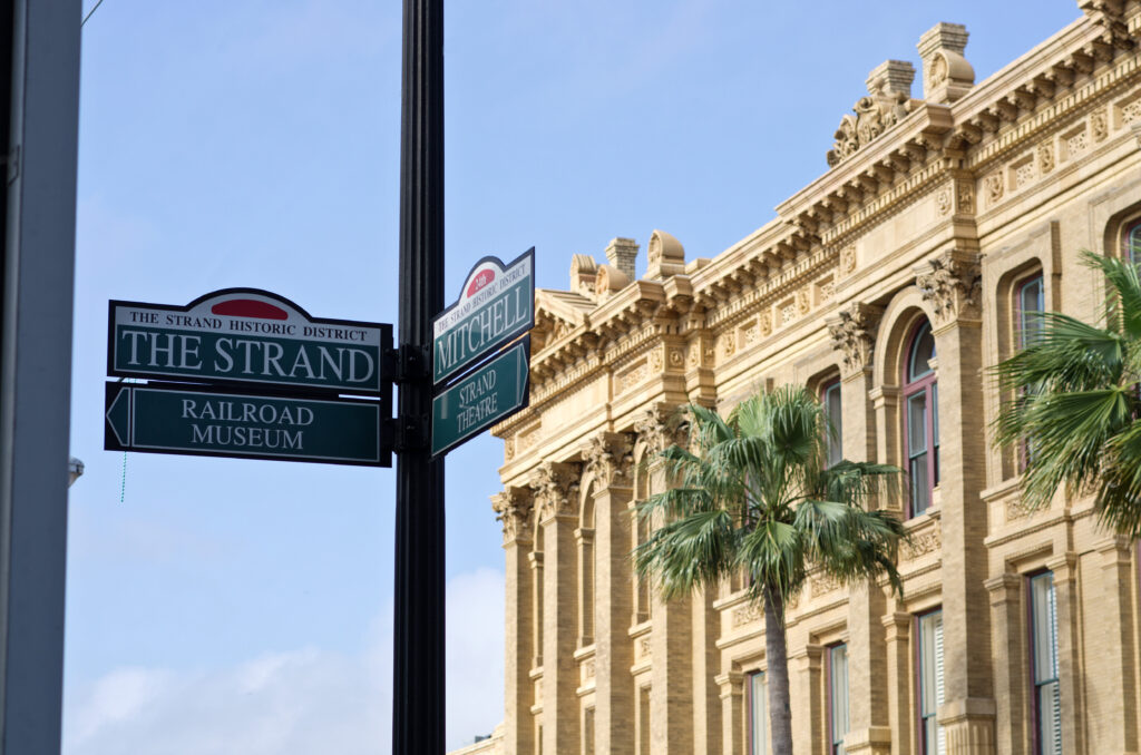 The Strand corner sign post in the historic downtown district of ...